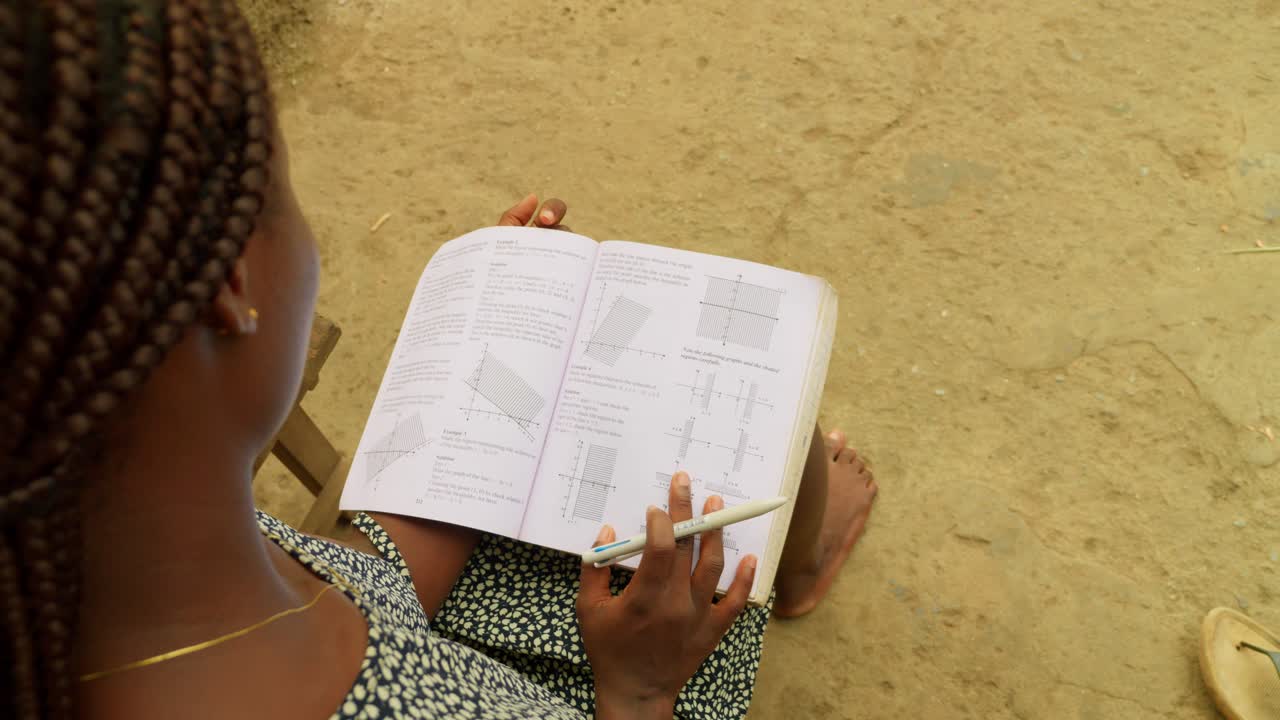 Skimming Through A Mathematics Book, A Young Ghanaian Woman Is Trying ...