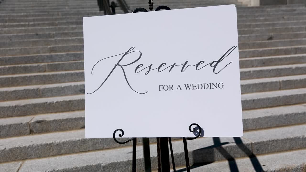 Reserved sigh on white poster near wedding reception building with ...