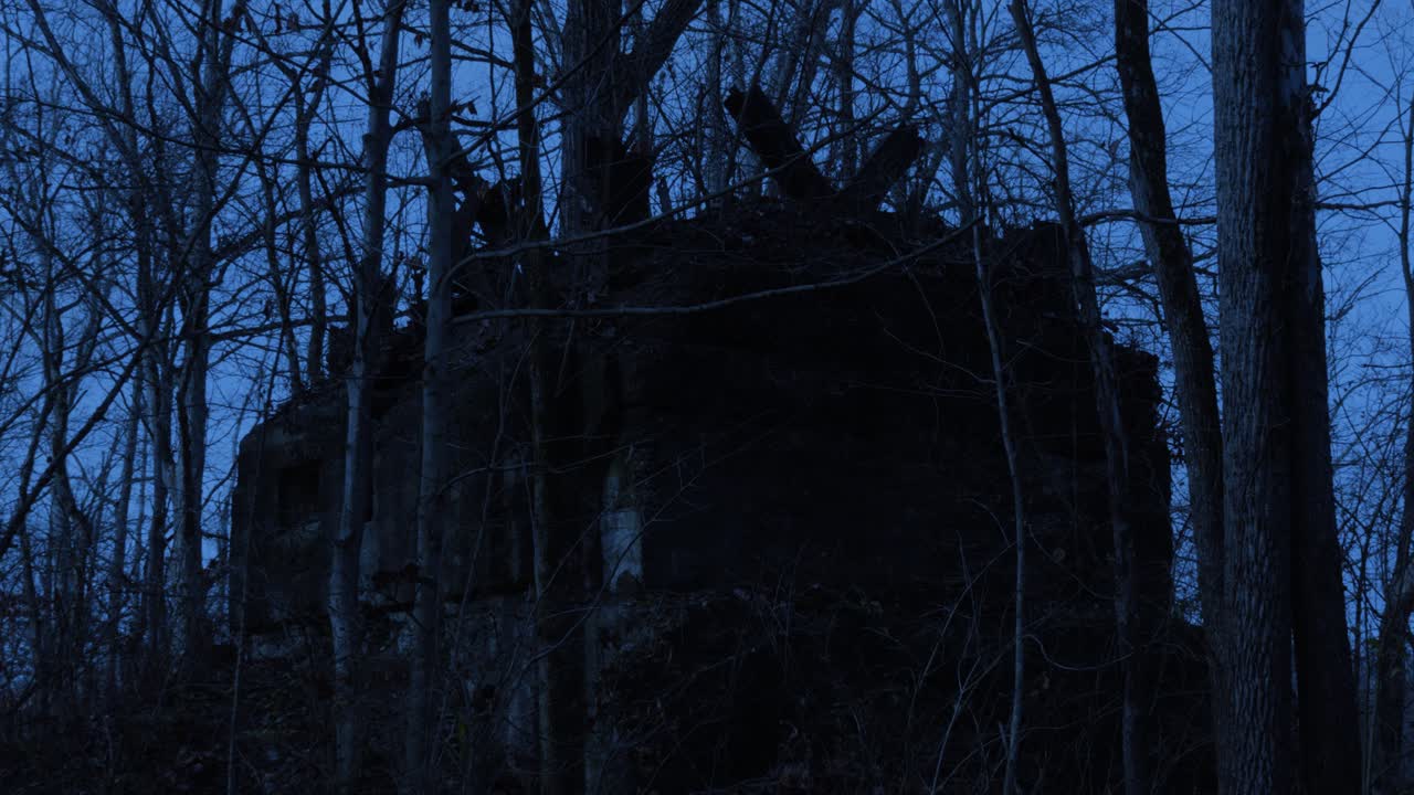 Broken down abandoned hut with collapsed roof in autumn bare tree ...