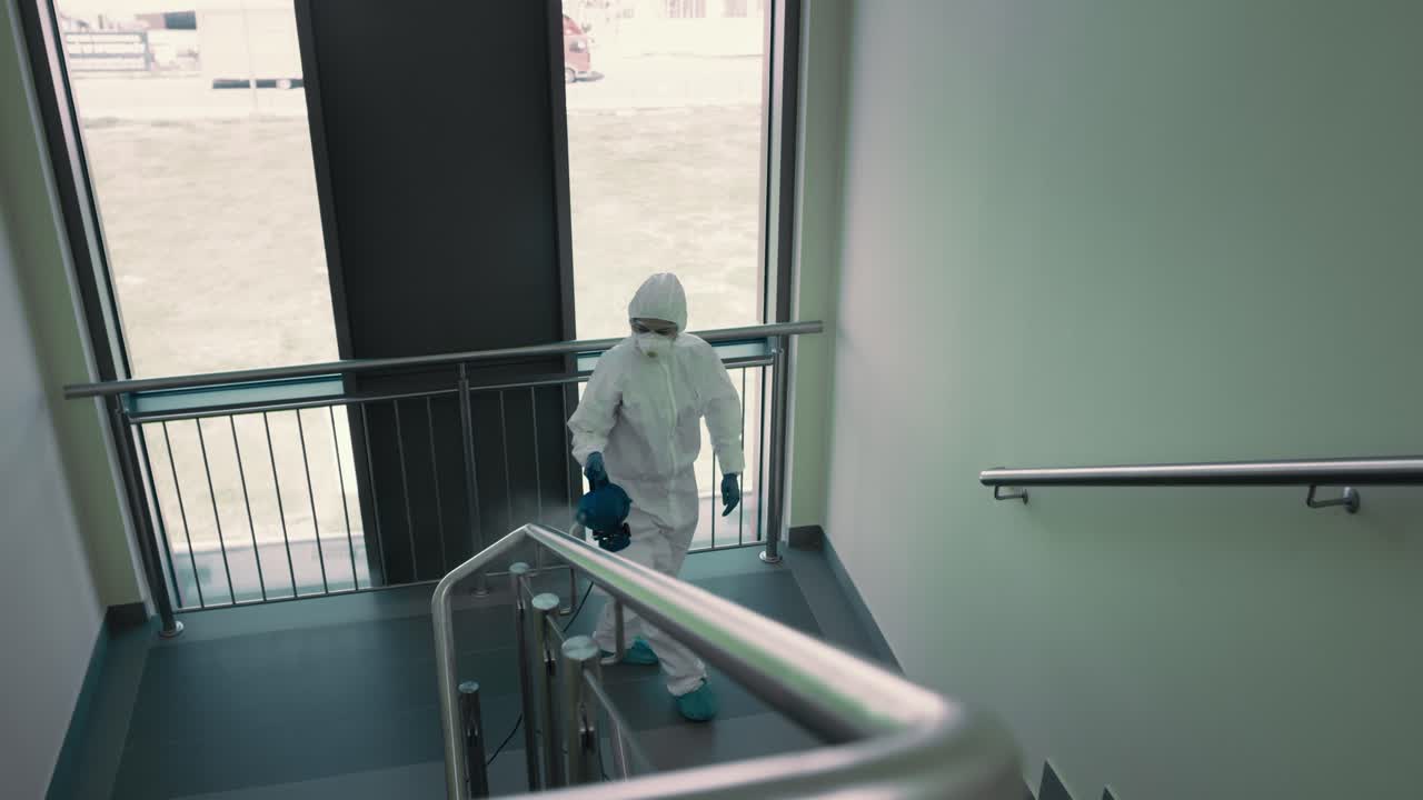 Premium stock video - Top view of sanitation worker disinfecting the ...