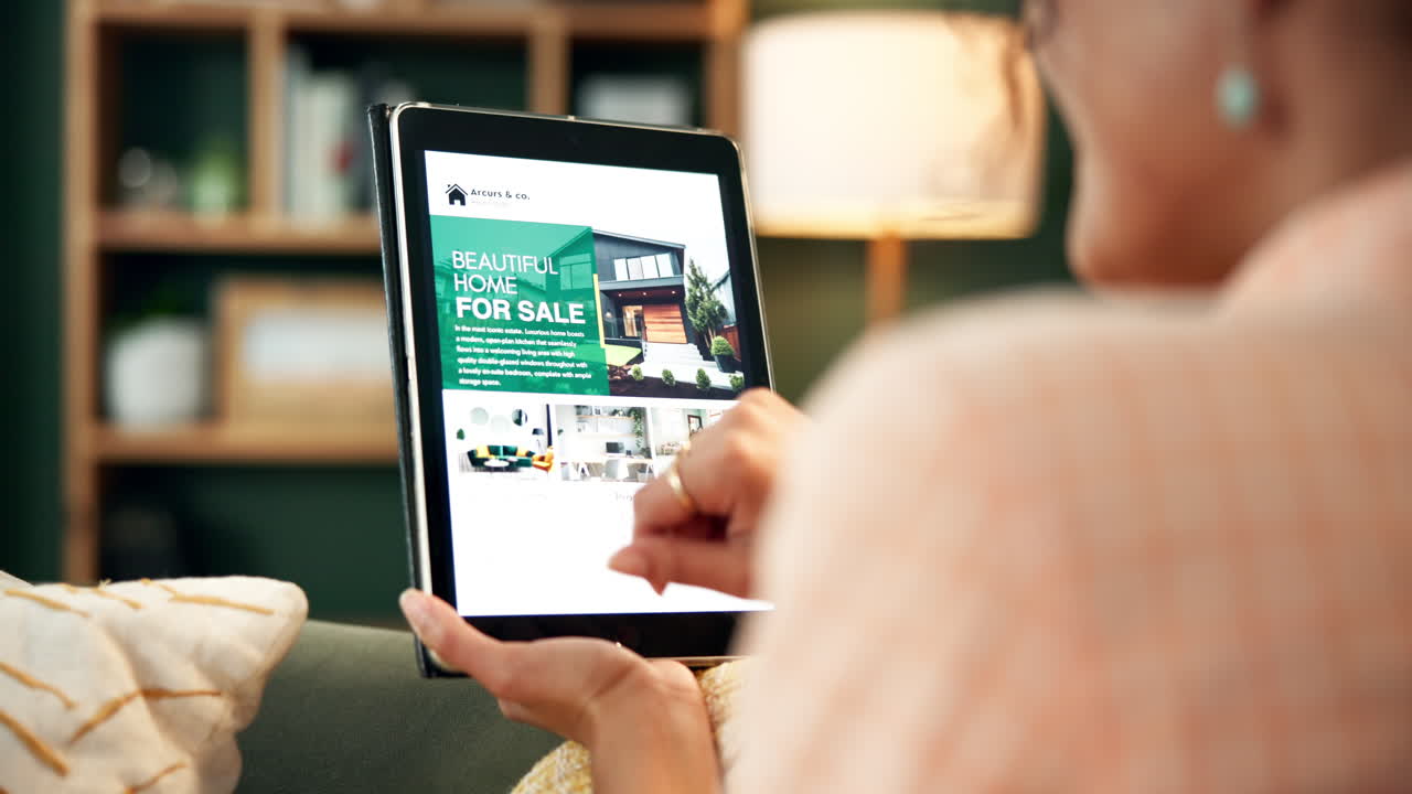 Woman browsing real estate listings on a tablet | Premium Stock Video ...