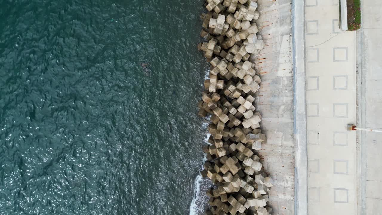 Premium stock video - Top down aerial view of concrete tetrapods lined ...