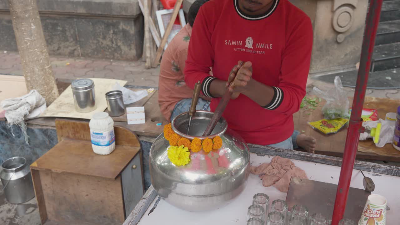 Free stock video - Close up of man on stall churning curd to make ...