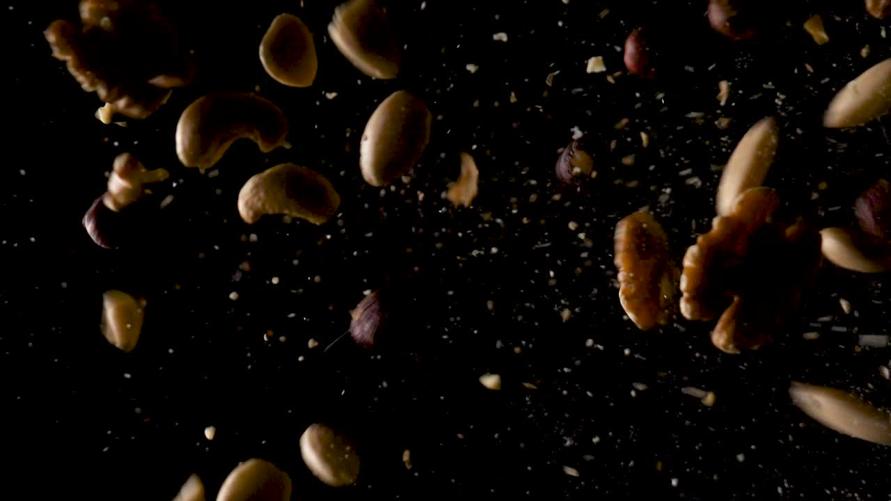 Premium stock video - Mixed nuts falling down from top in slow motion ...