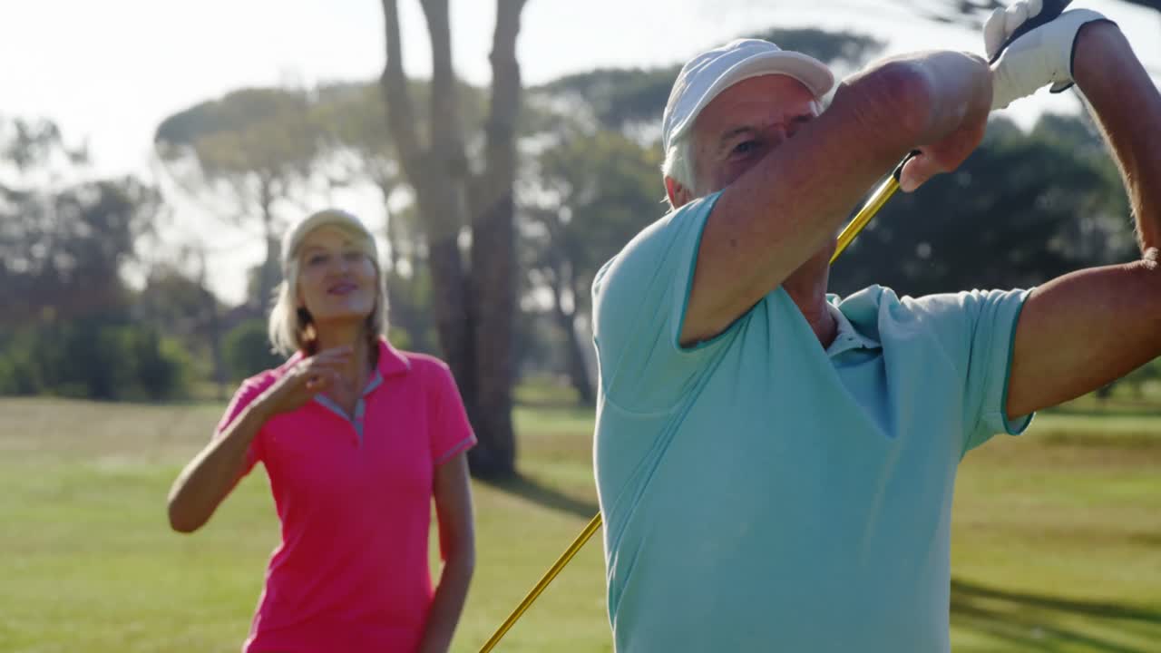 Premium stock video - Two golfers playing golf together
