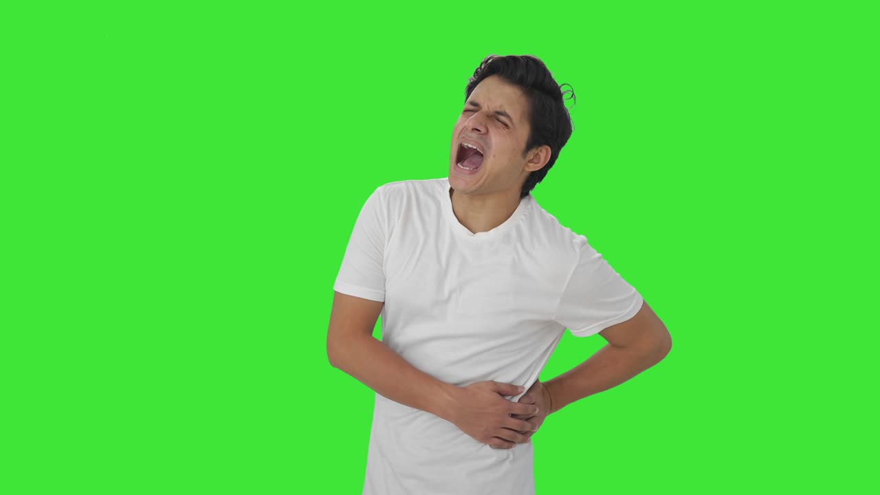 Premium stock video - Sick indian man having back pain green screen