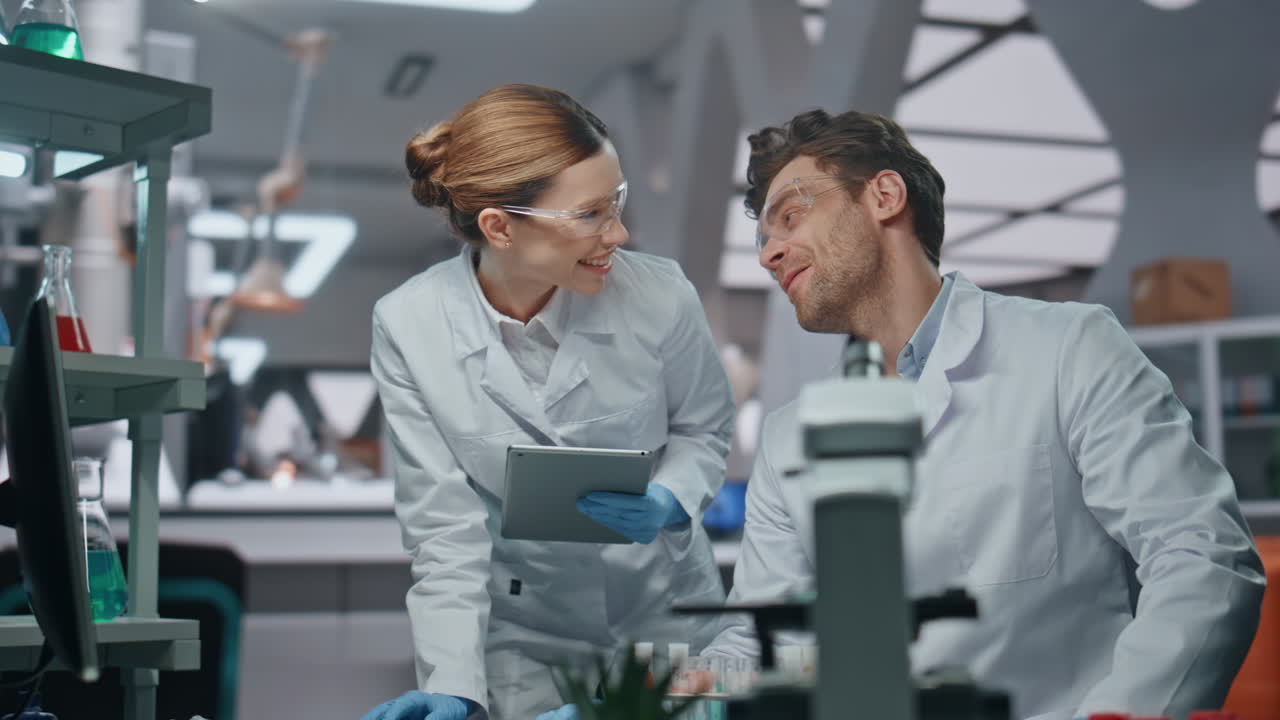 Couple scientists working modern laboratory close up. Smiling lab ...