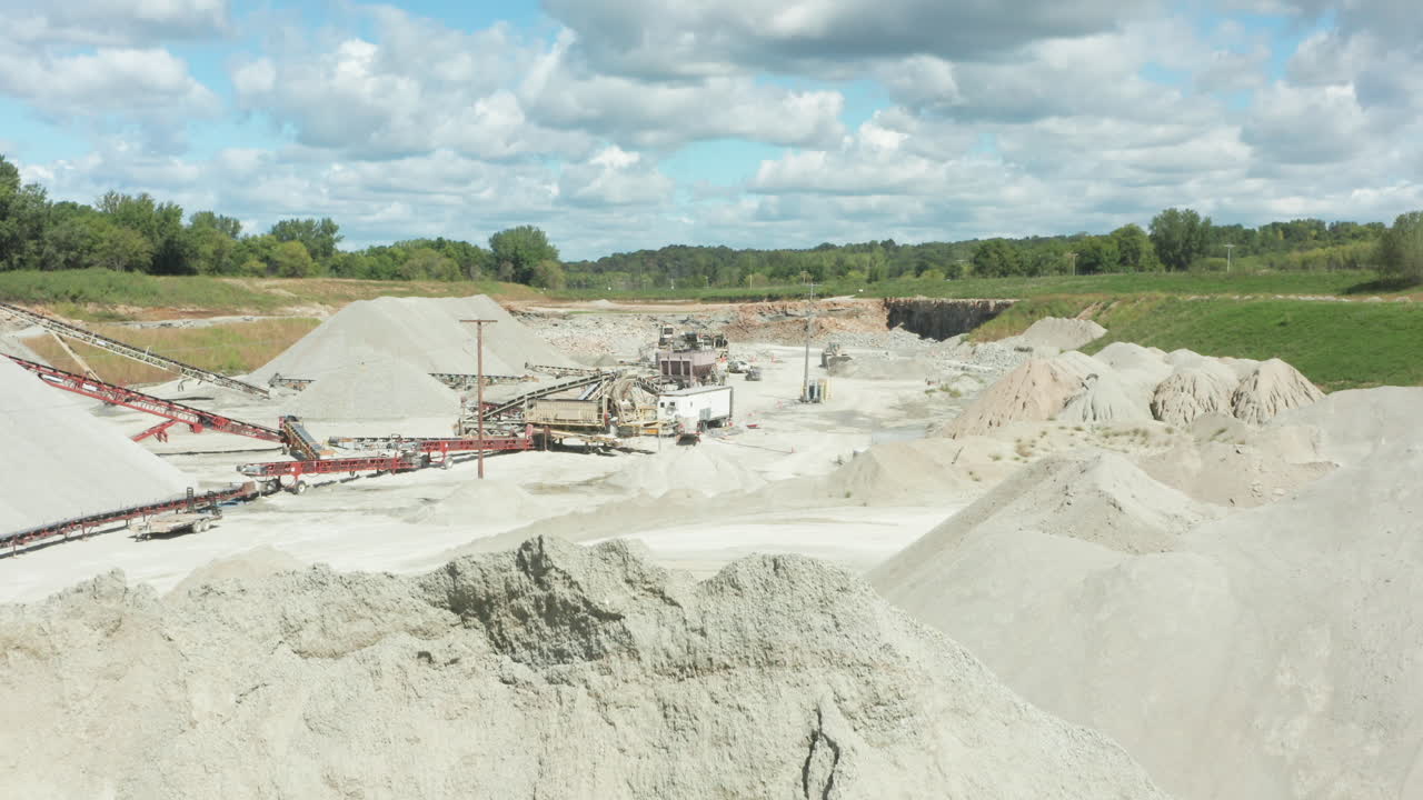 Drone Ascends Revealing Limestone Sand Quarry Behind Large Pile For ...