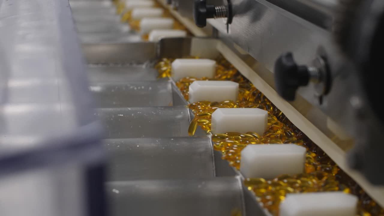 4K video of vitamins being sorted before moving into a count base batch ...