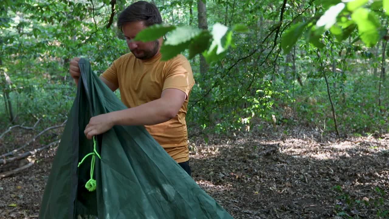 Slow Motion Of A Tourist Packing Up A Tent At Forest Campsite And ...