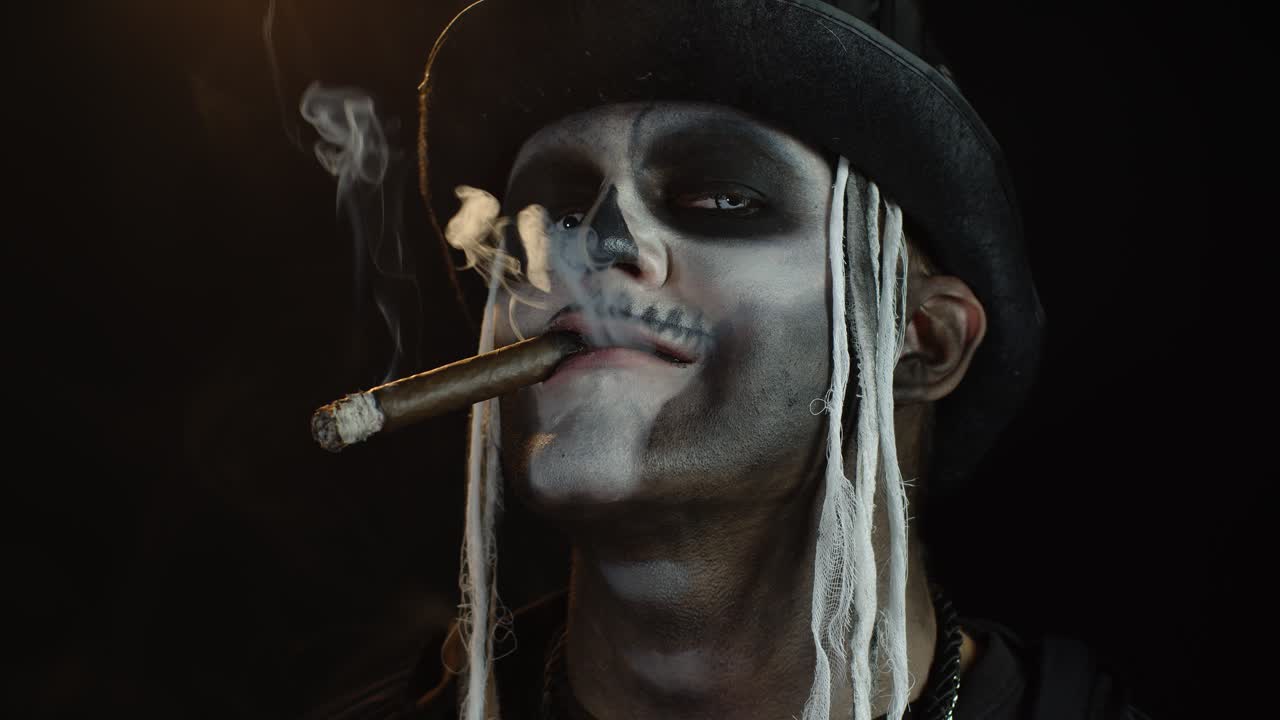 scary guy in professional carnival makeup of halloween skeleton smoking ...