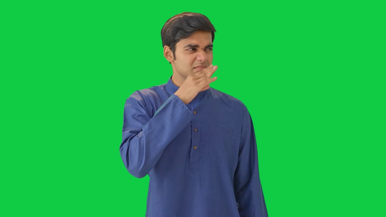 Premium stock video - Indian man disgusted by bad smell green screen