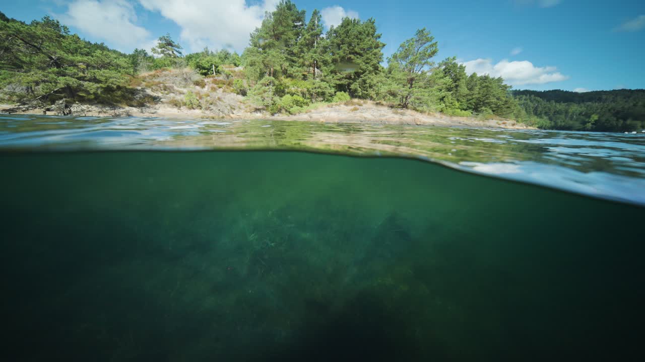 Premium stock video - Fjord over and under water split view