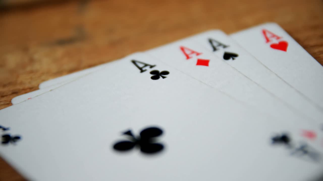 Premium stock video - Playing cards on wooden table 4k