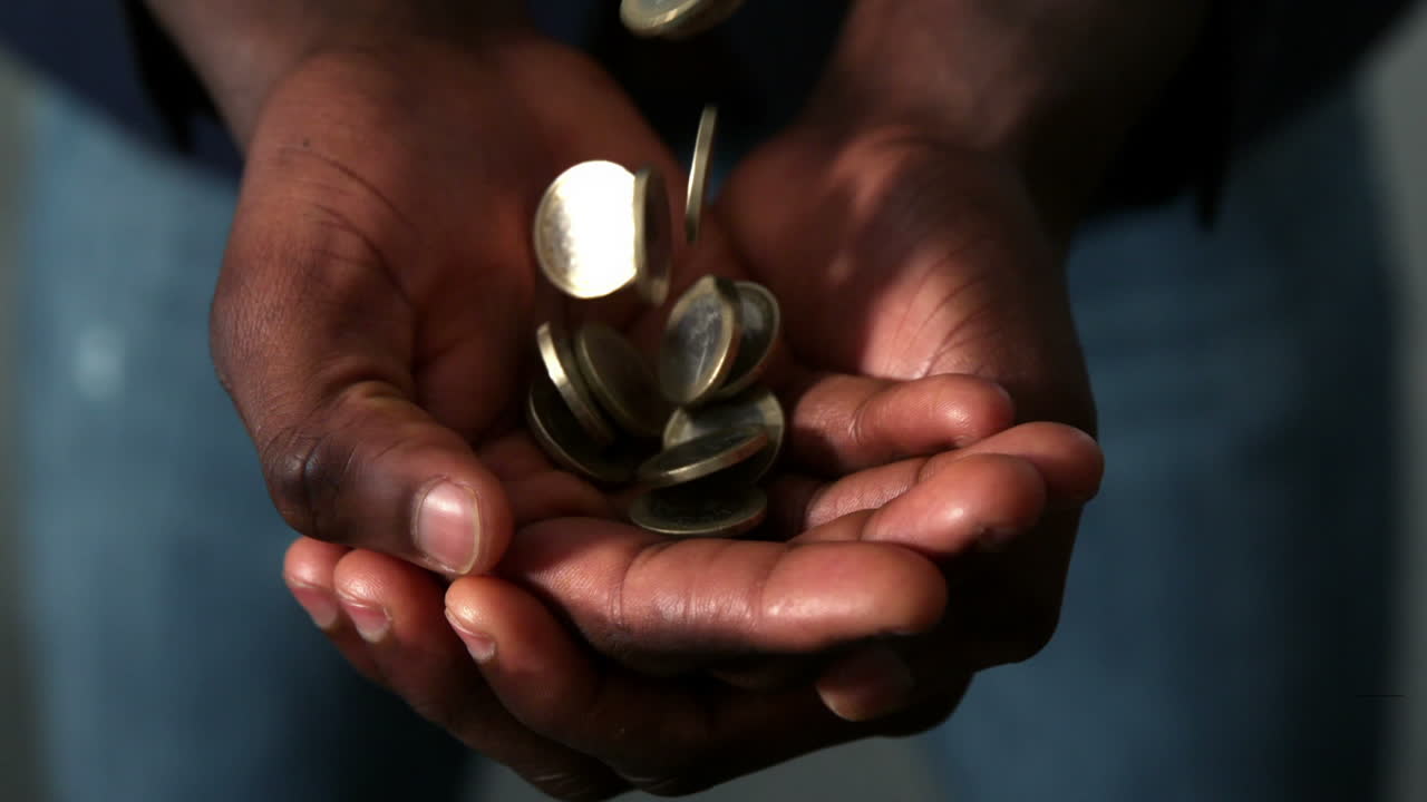 Man catching falling coins in hands Premium Stock Video Footage