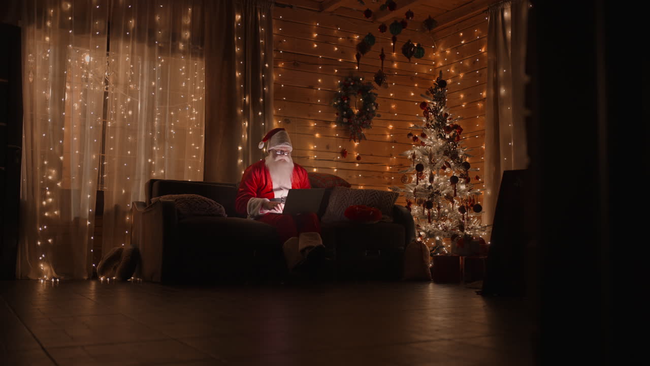 The general plan: santa claus working on laptop sends letters with ...